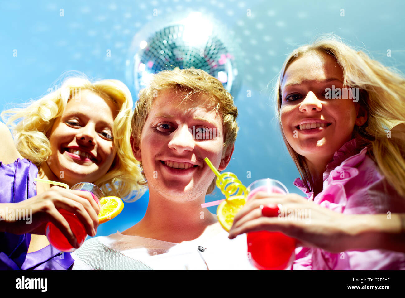 Below angle of cheerful company with cocktails looking at camera Stock ...