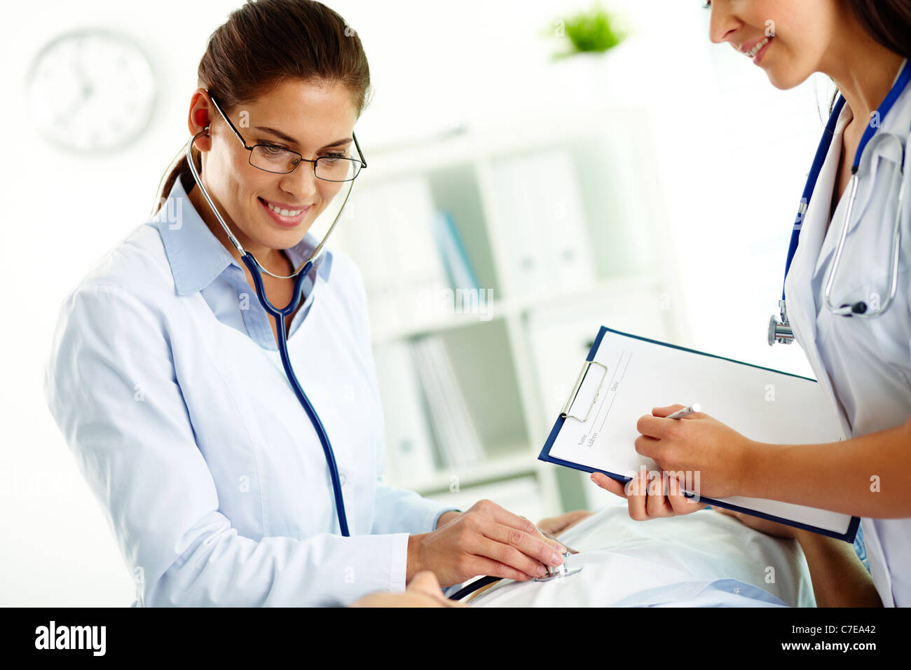 Portrait of confident female doctors during medical treatment of ...