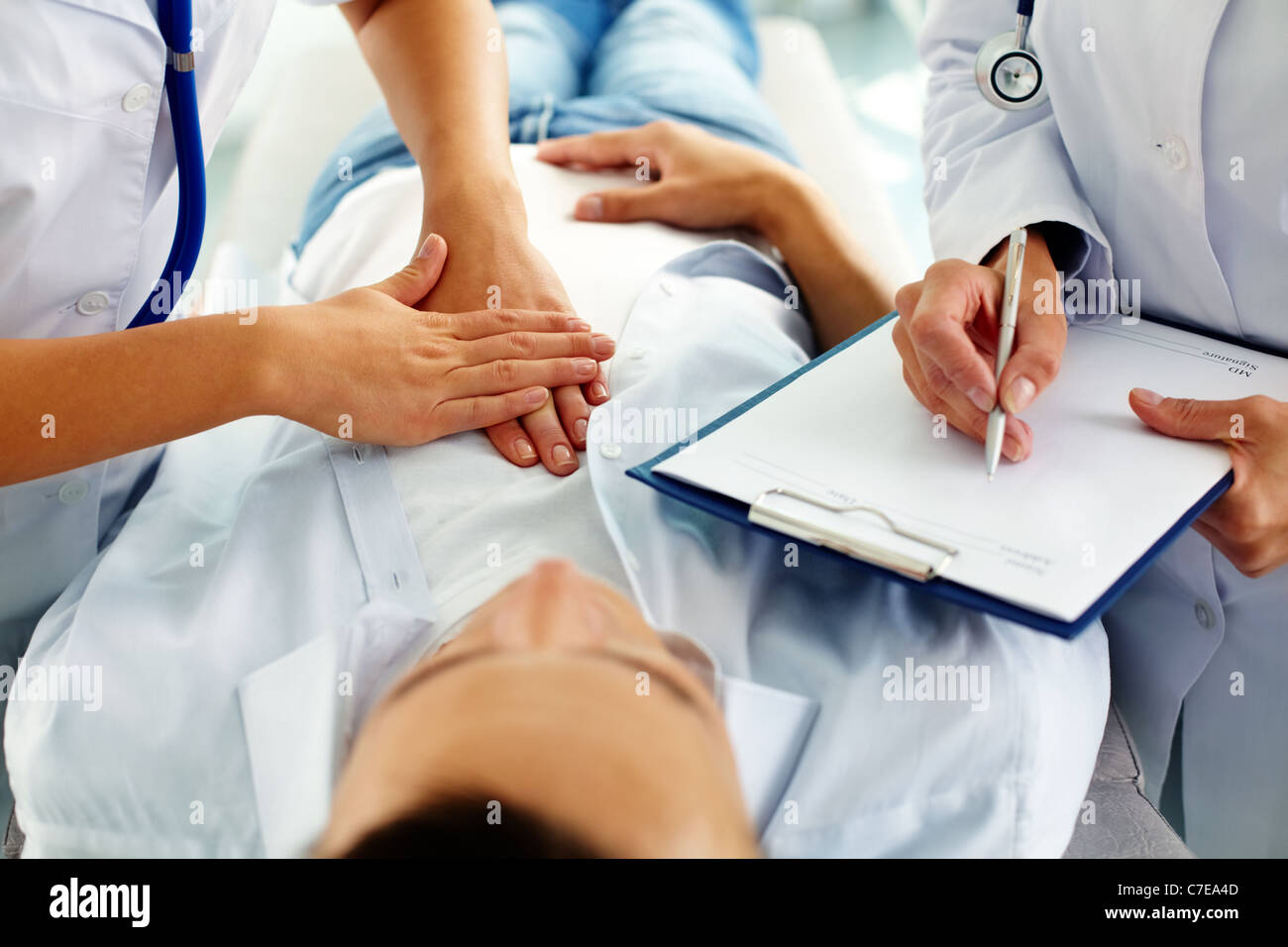 Close-up of two doctors during medical treatment of patient in hospital ...