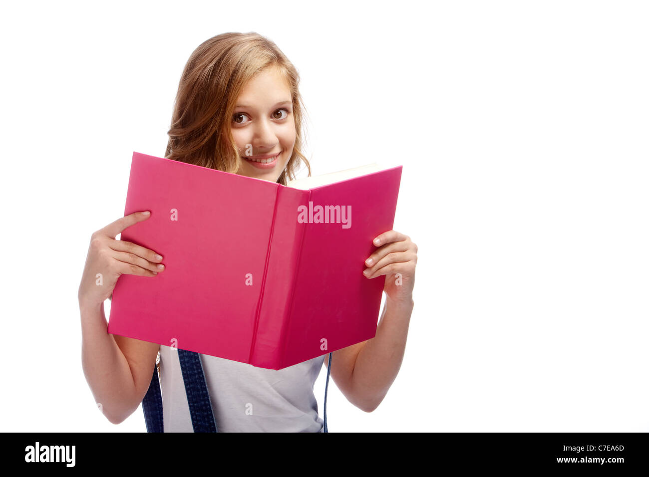 Cute girl with open book looking at camera in isolation Stock Photo - Alamy