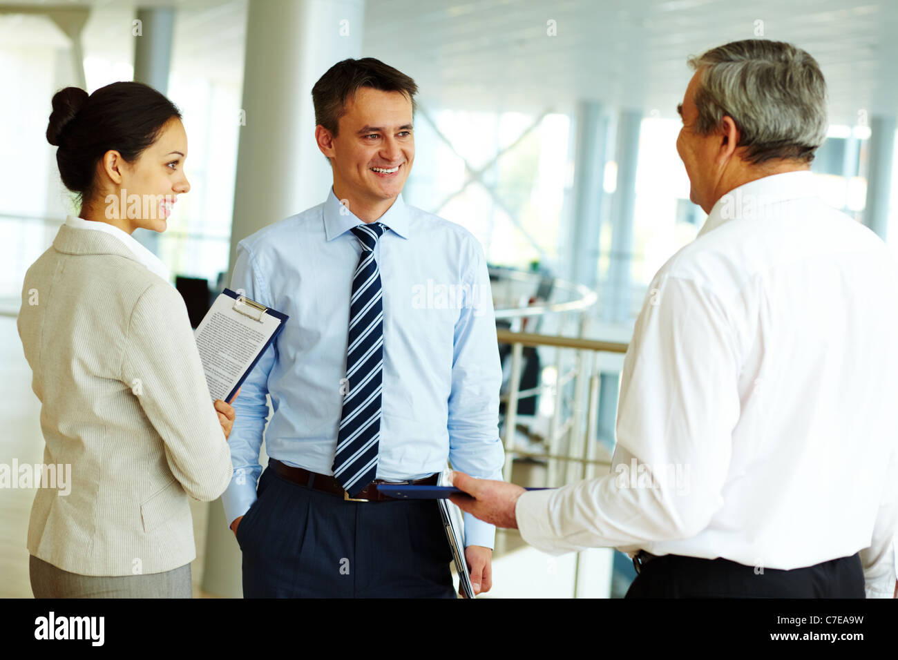 Portrait of busy people discussing new working plan or idea Stock Photo ...