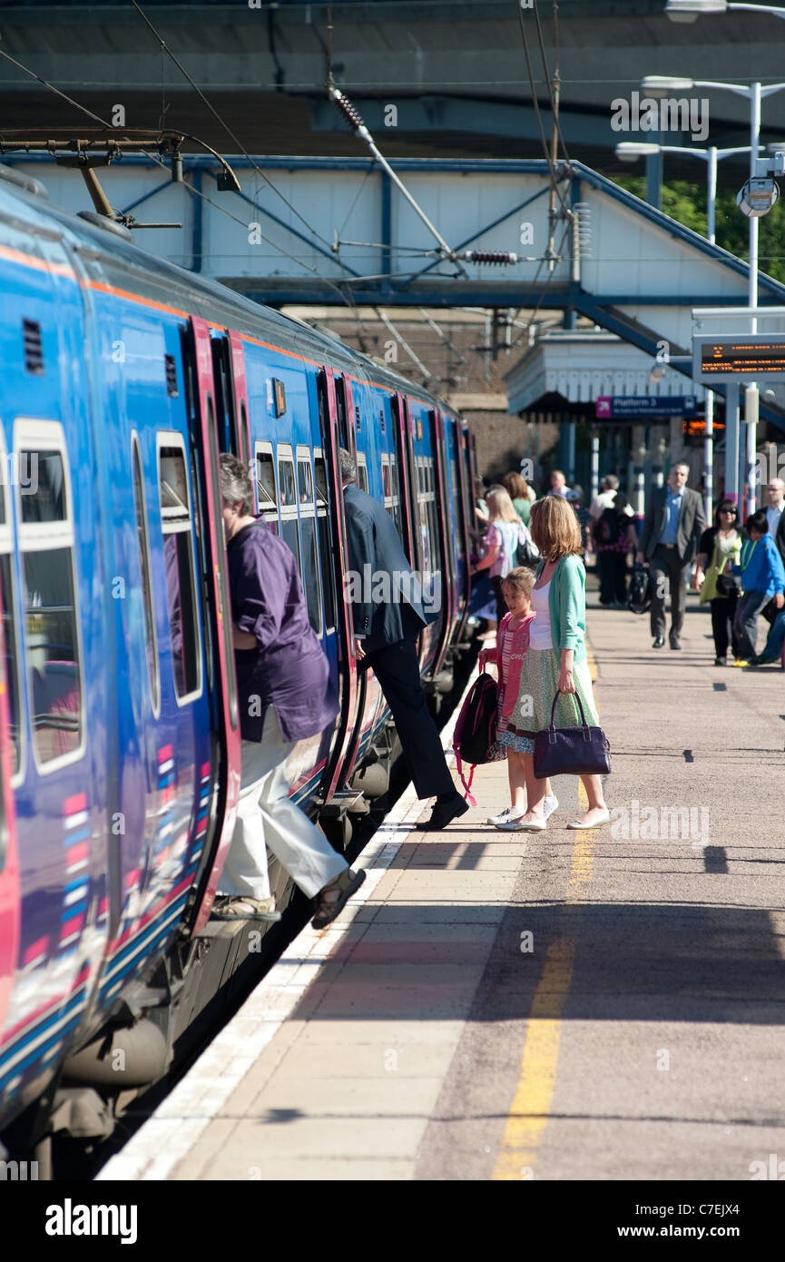 Passengers boarding a First Capital Connect train at a railway station ...