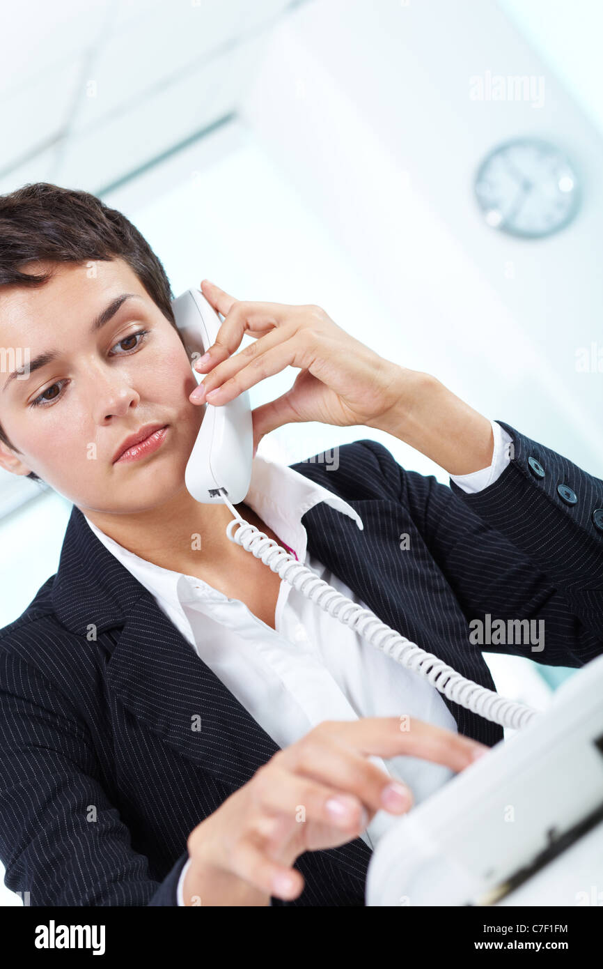 Photo of smart businesswoman pressing phone buttons in office Stock ...
