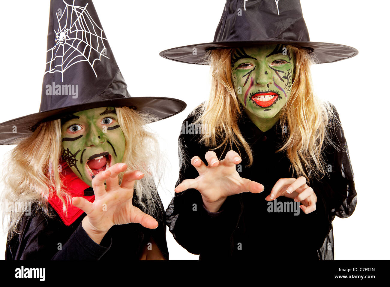 Two scary little green witches for Halloween over white background ...