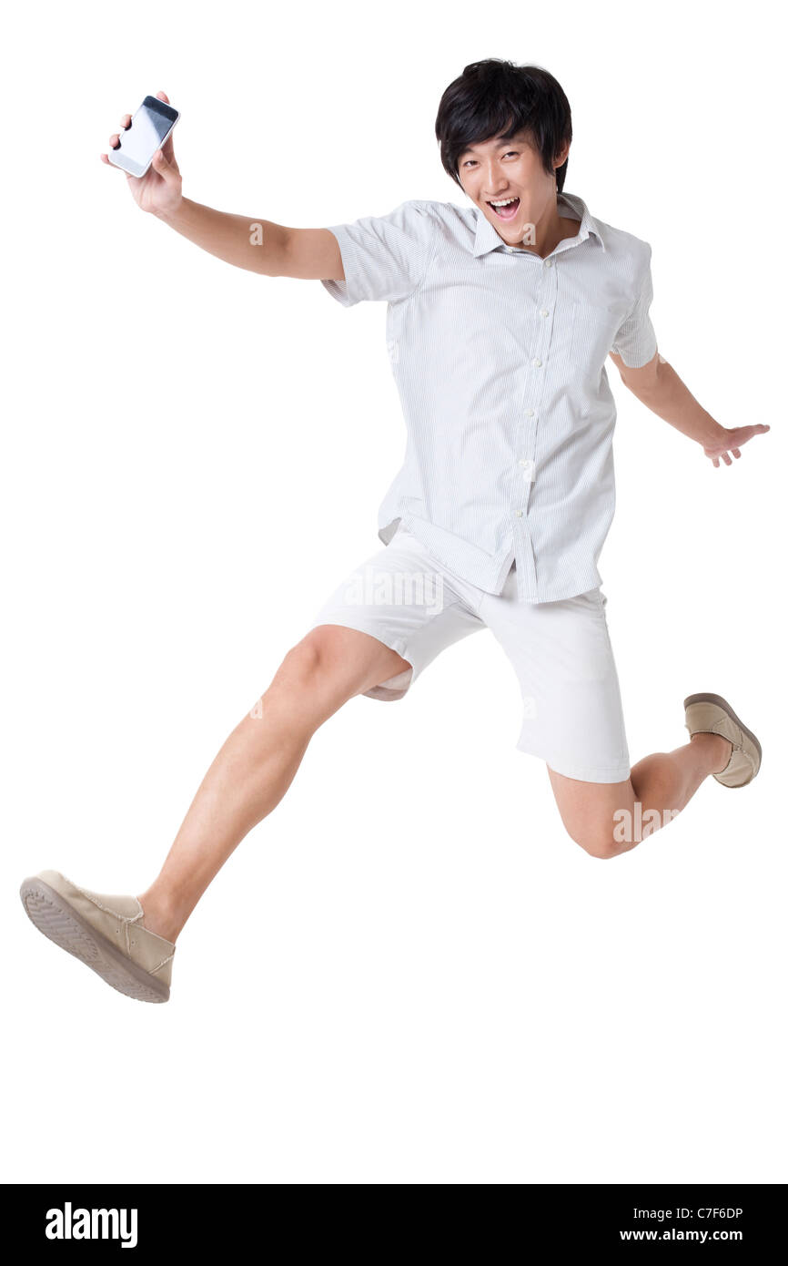 Young Man Jumping With a Mobile Phone Stock Photo - Alamy