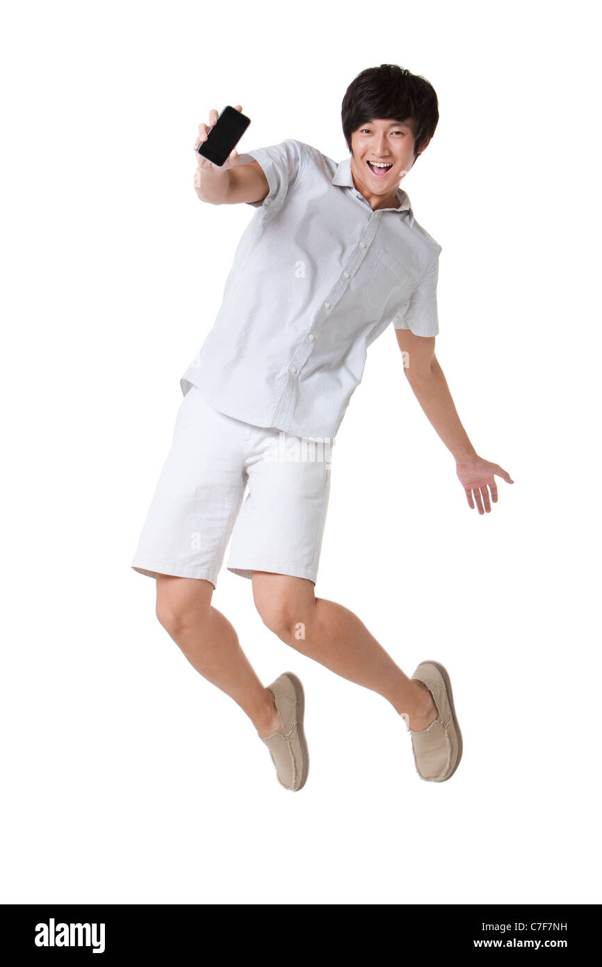 Young Man Jumping With a Mobile Phone Stock Photo - Alamy