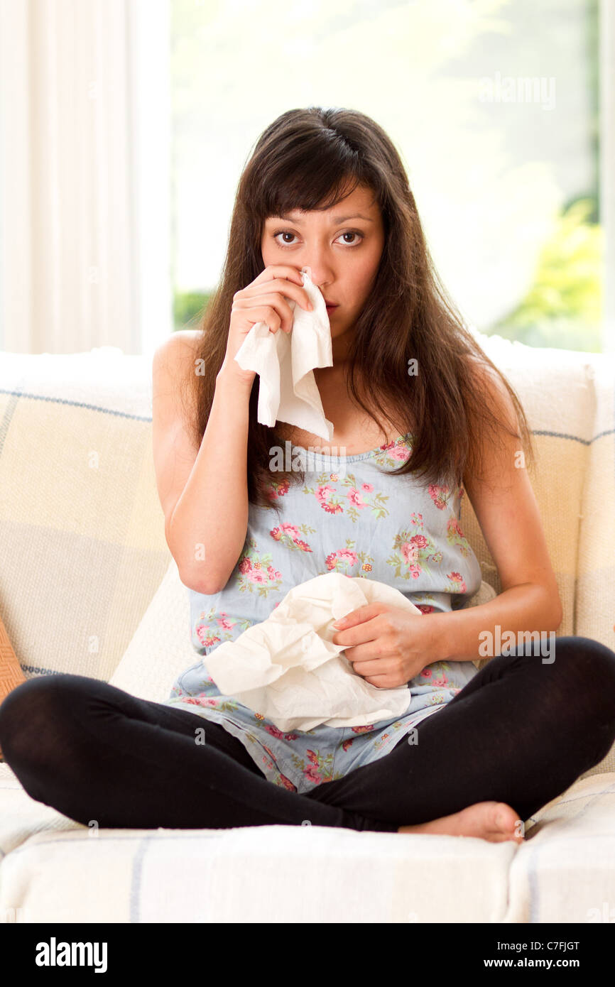 Girl with cold blowing nose Stock Photo - Alamy
