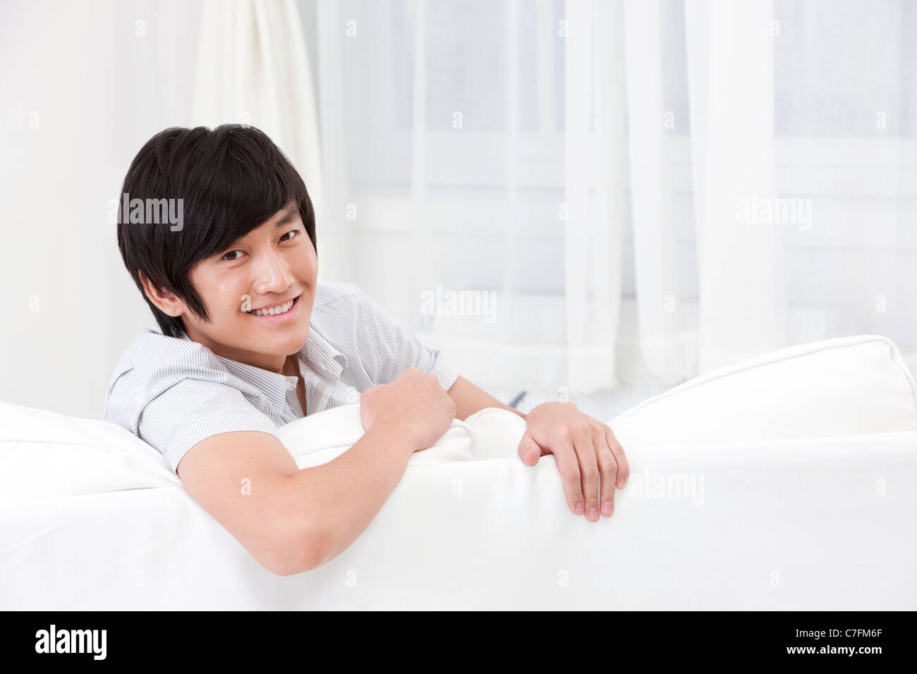 Young Man Relaxing at Home Stock Photo - Alamy