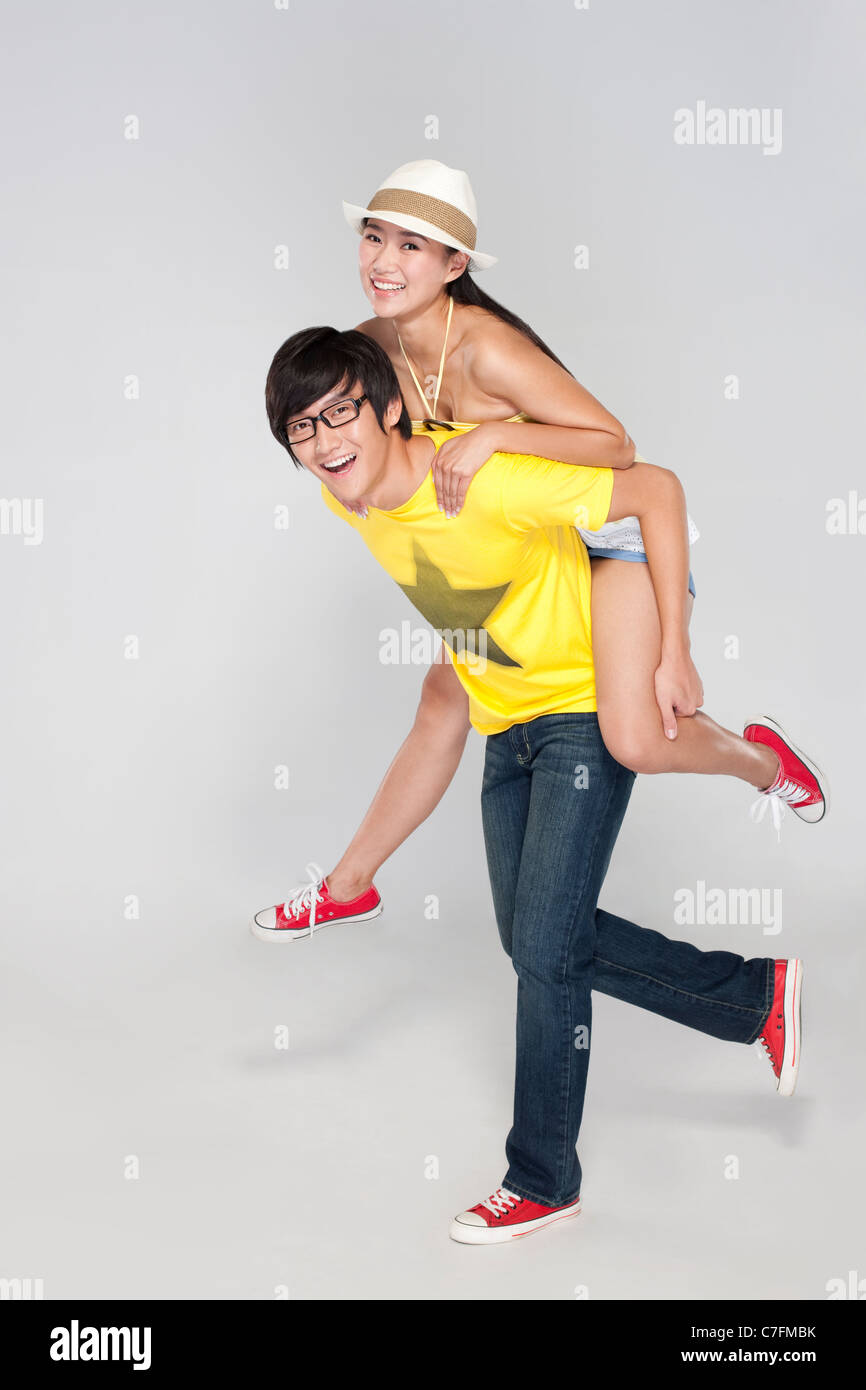 Young Man Carrying Girlfriend on Back Stock Photo - Alamy