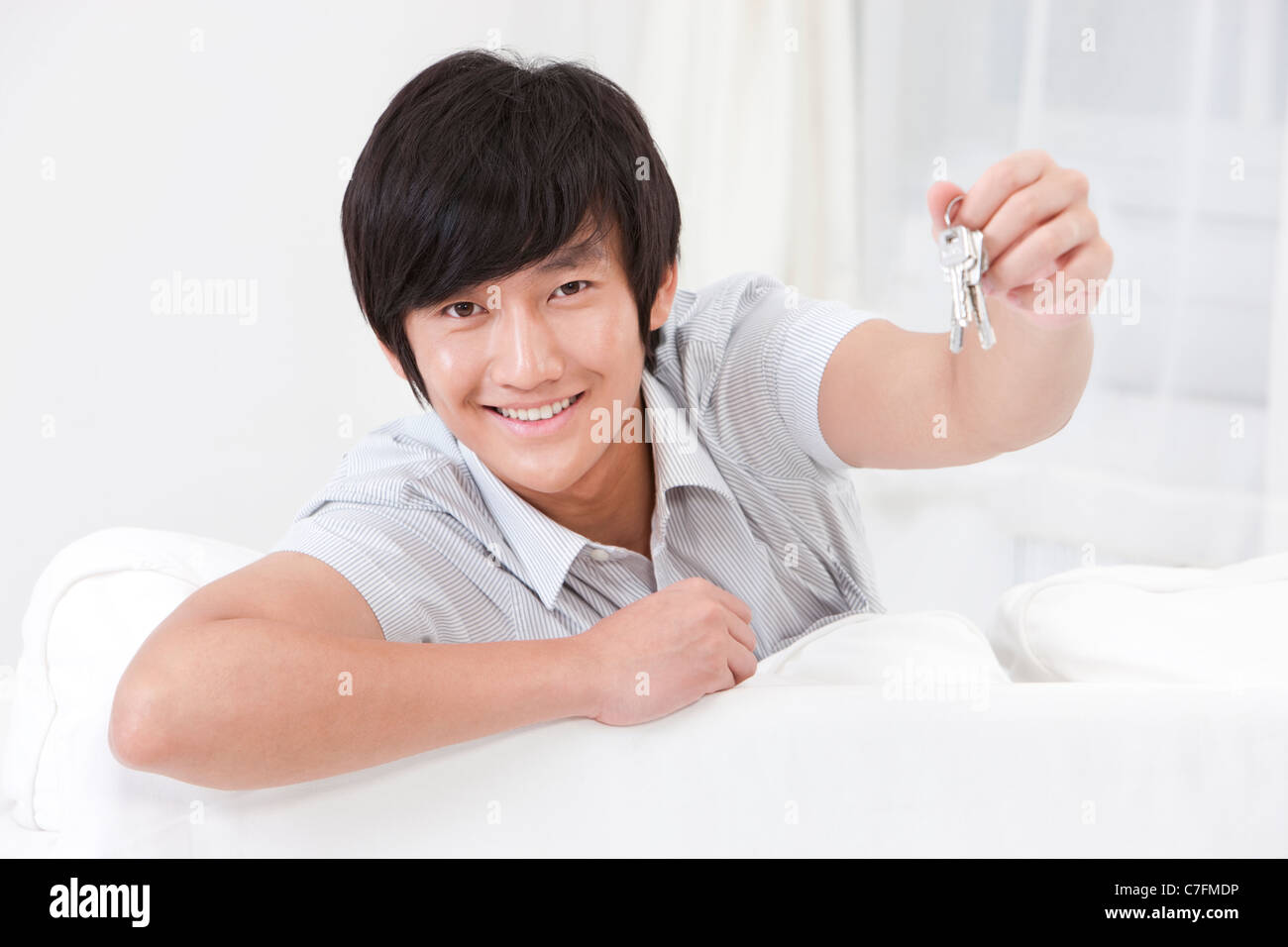 Young Man Holding Keys Stock Photo - Alamy