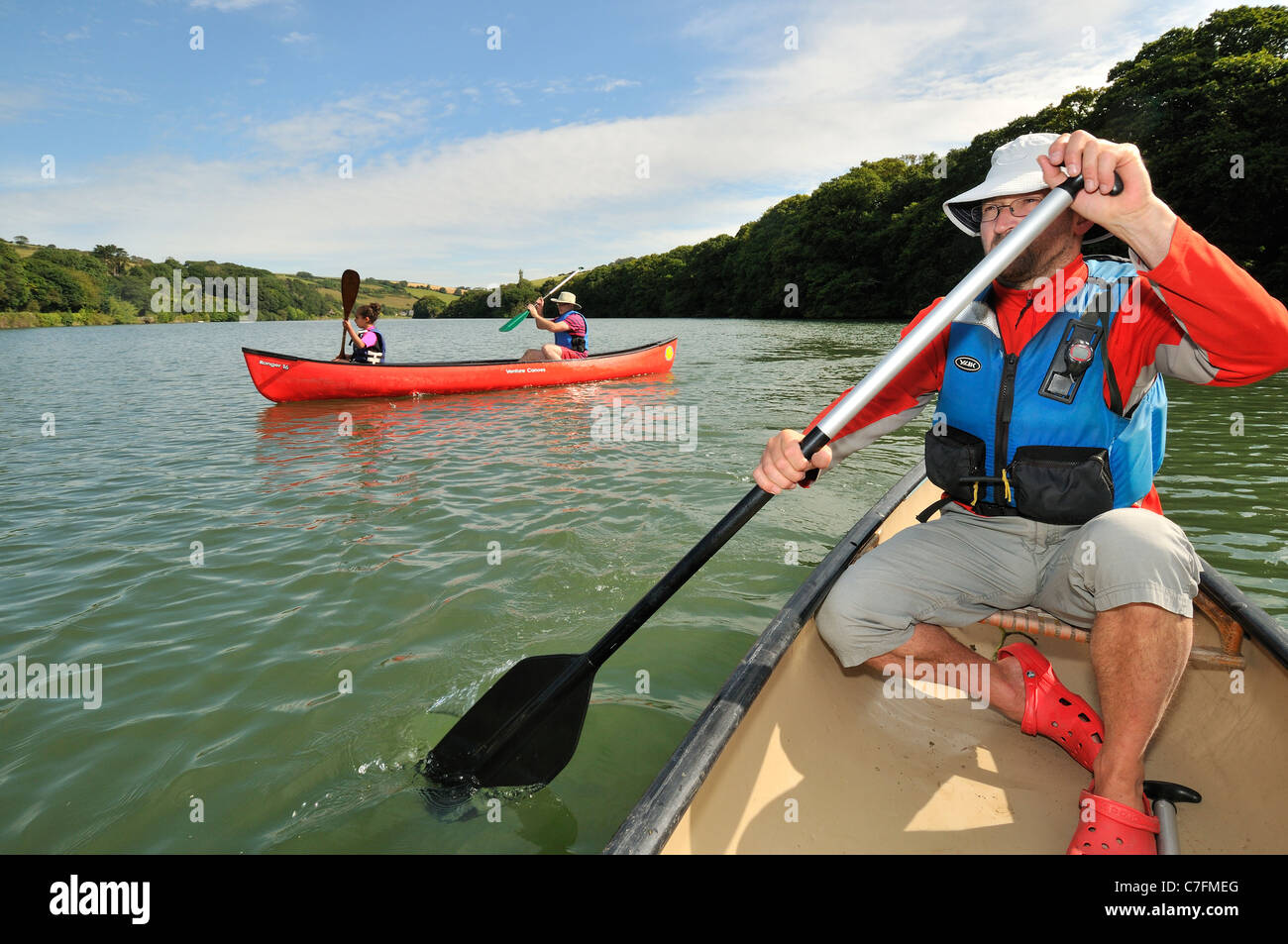 Digging in the paddle in single paddle canoe on safari at New Bridge ...