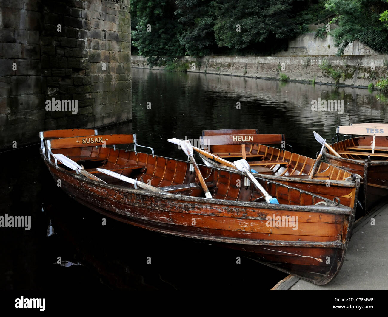 Three old wooden punts on the river wear in Durham that are named Susan ...