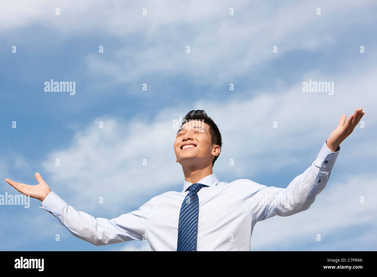 Businessman Standing with Arms Outstretched Stock Photo - Alamy