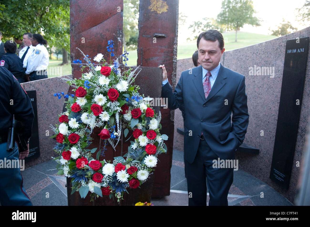 Texas Agriculture Commissioner Todd Staples poses with spray of flowers ...