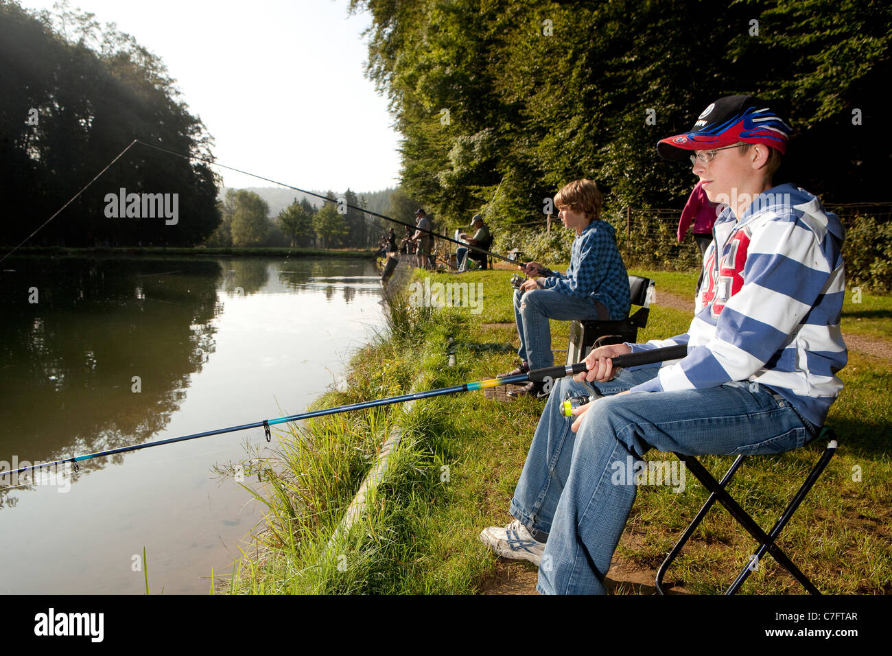 Young Fisher at a fishing lake in Fischbach, Luxembourg Stock Photo - Alamy