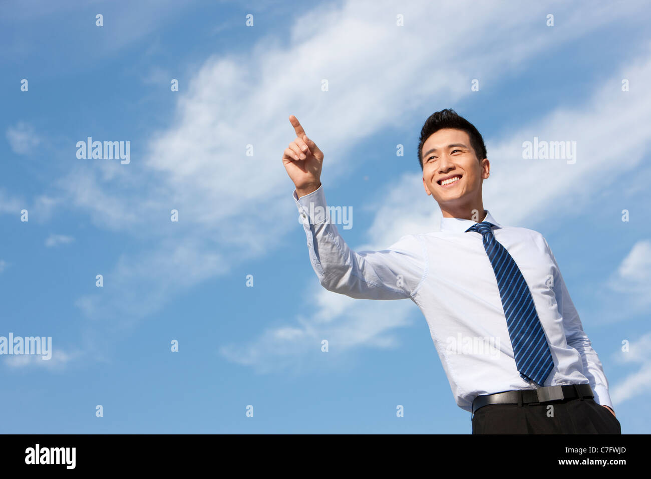Businessman Pointing Upwards Stock Photo - Alamy