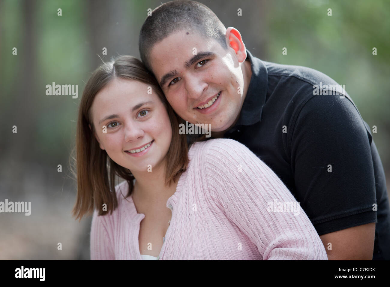 Happy young couple outdoors. She is Caucasian, he is Native American ...
