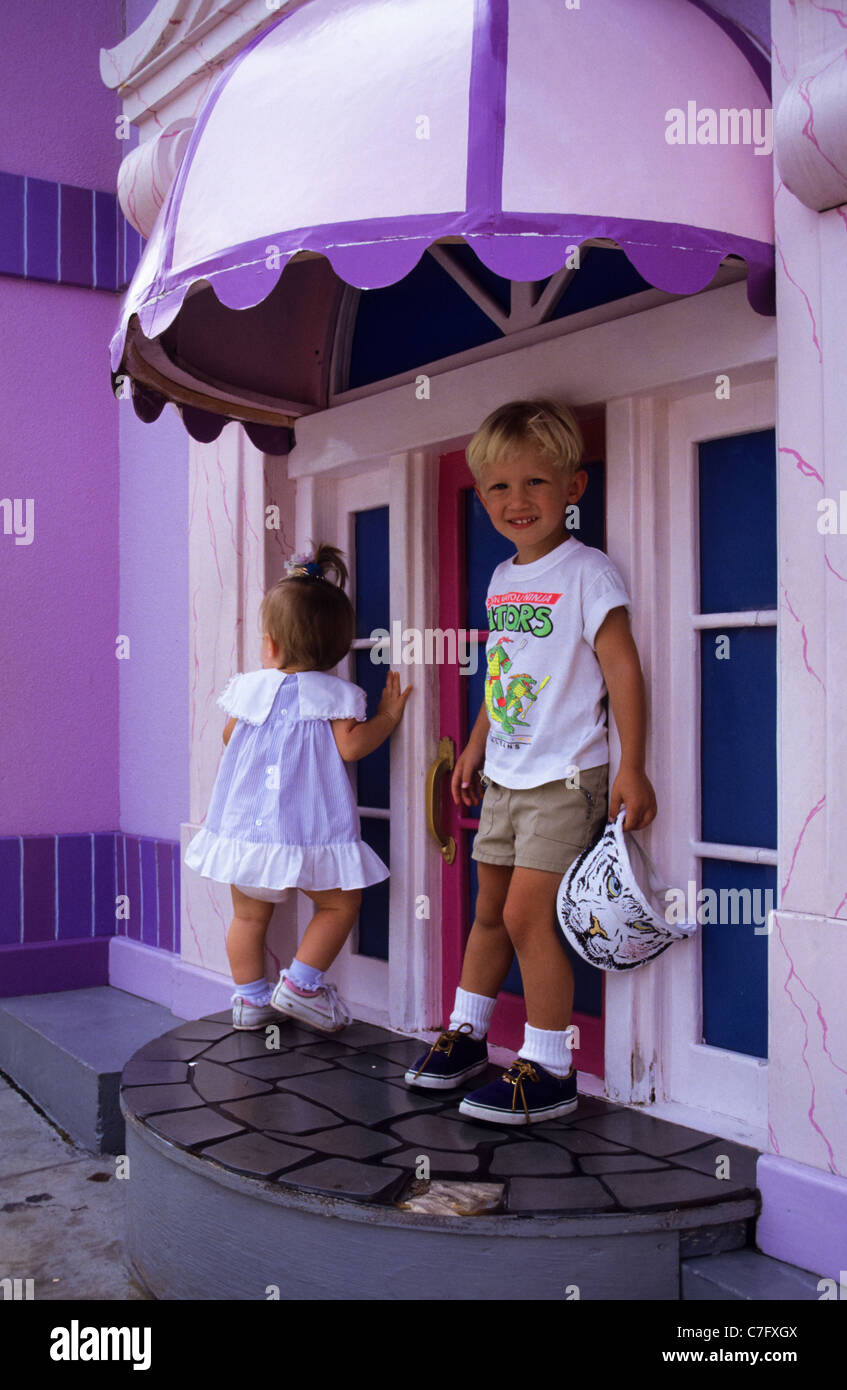 Small boy and girl outside a pink toy house in Disney World, Florida ...