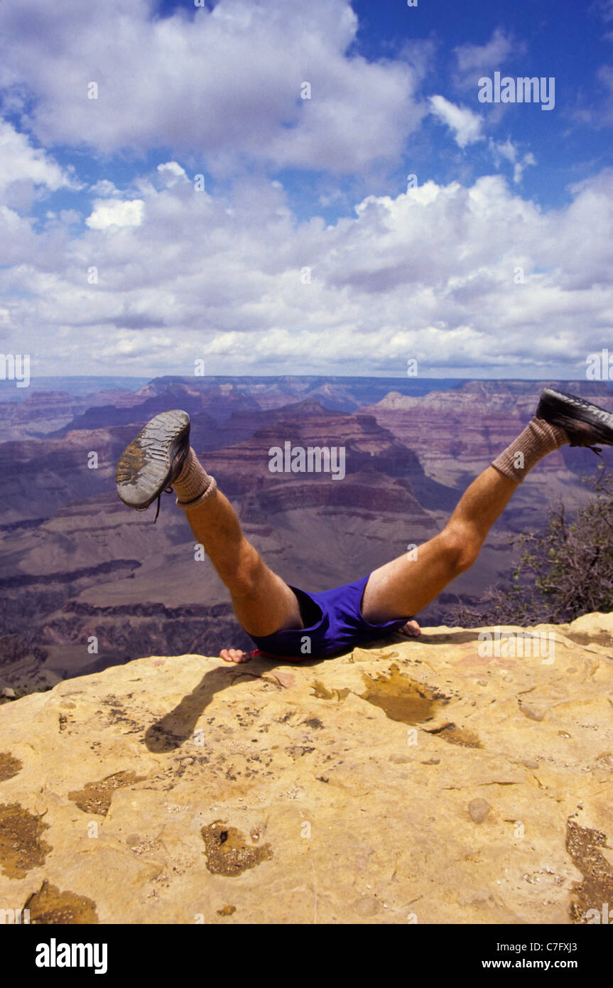 Man nose diving into Grand Canyon, with the legs in the air. Arizona ...