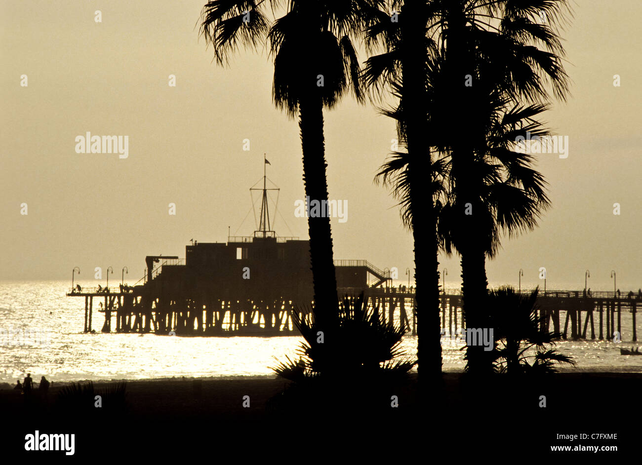 The Venice pier and palm trees in a silhouette against the afternoon ...
