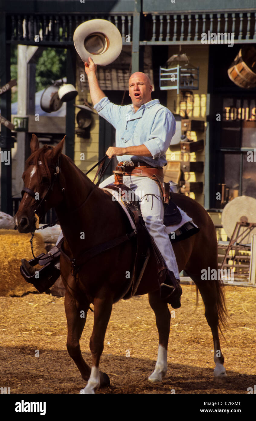 Wild west cowboy on a horse waving his hat at the Knotts Berryfarm in ...