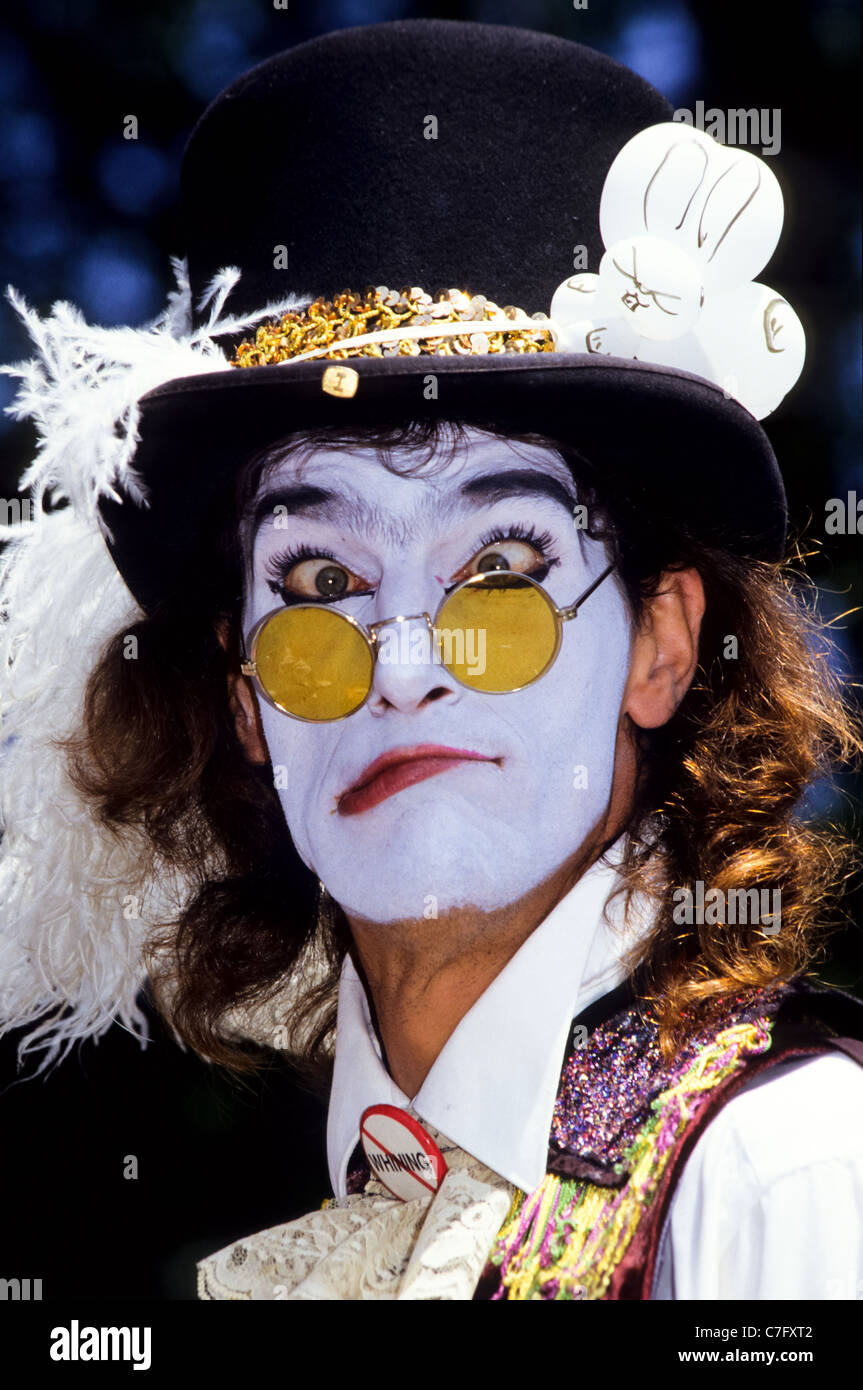 Clown with yellow glasses and bowler hat making faces Stock Photo - Alamy