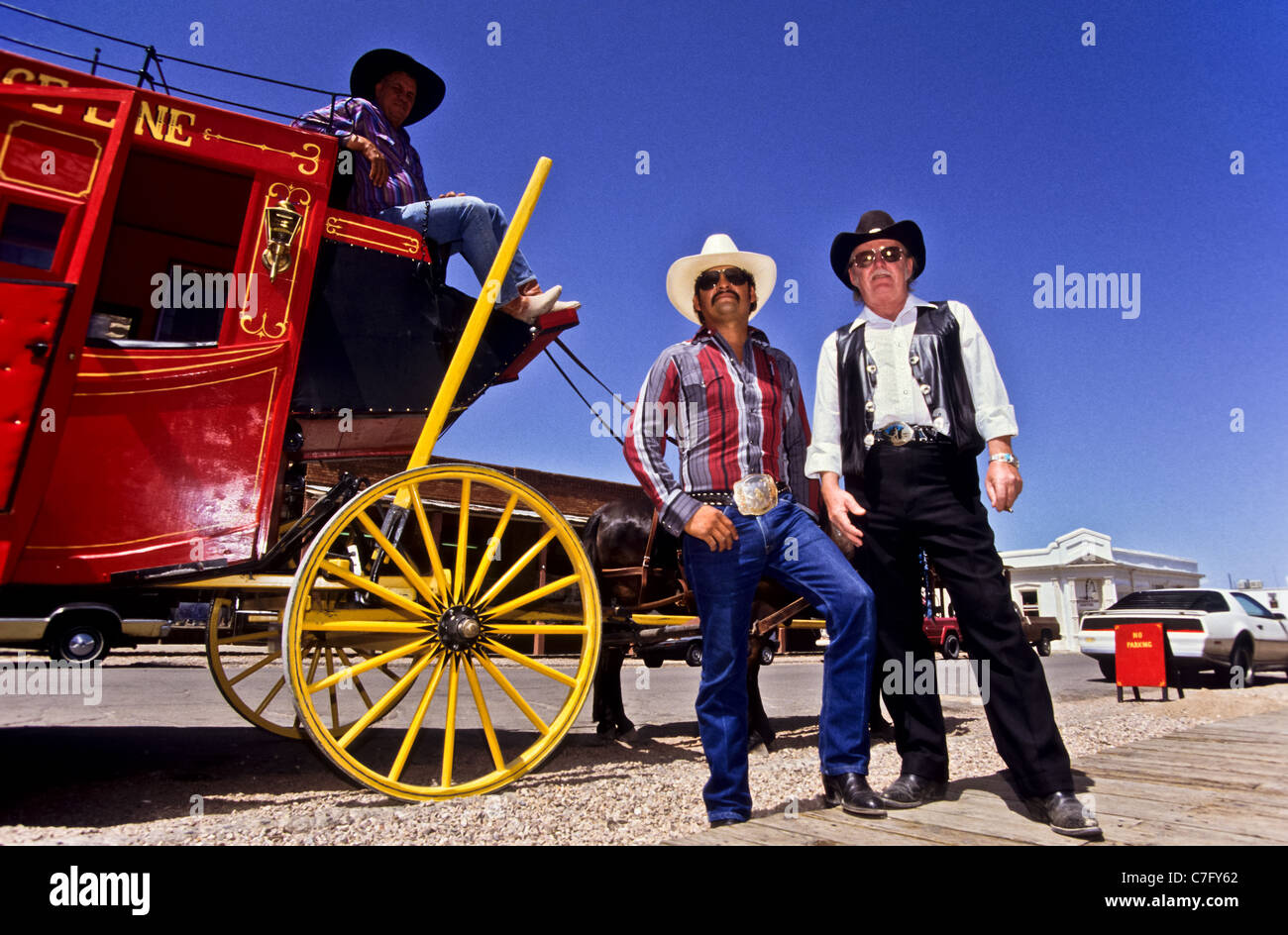 Three cowboys with their reed horse wagon in Tombstone, Arizona, USA ...