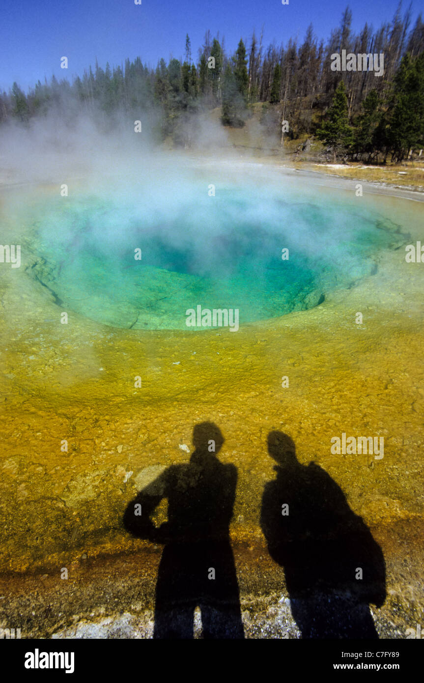 Morning Glory Pool in Yellowstone with the shadow of two tourists ...