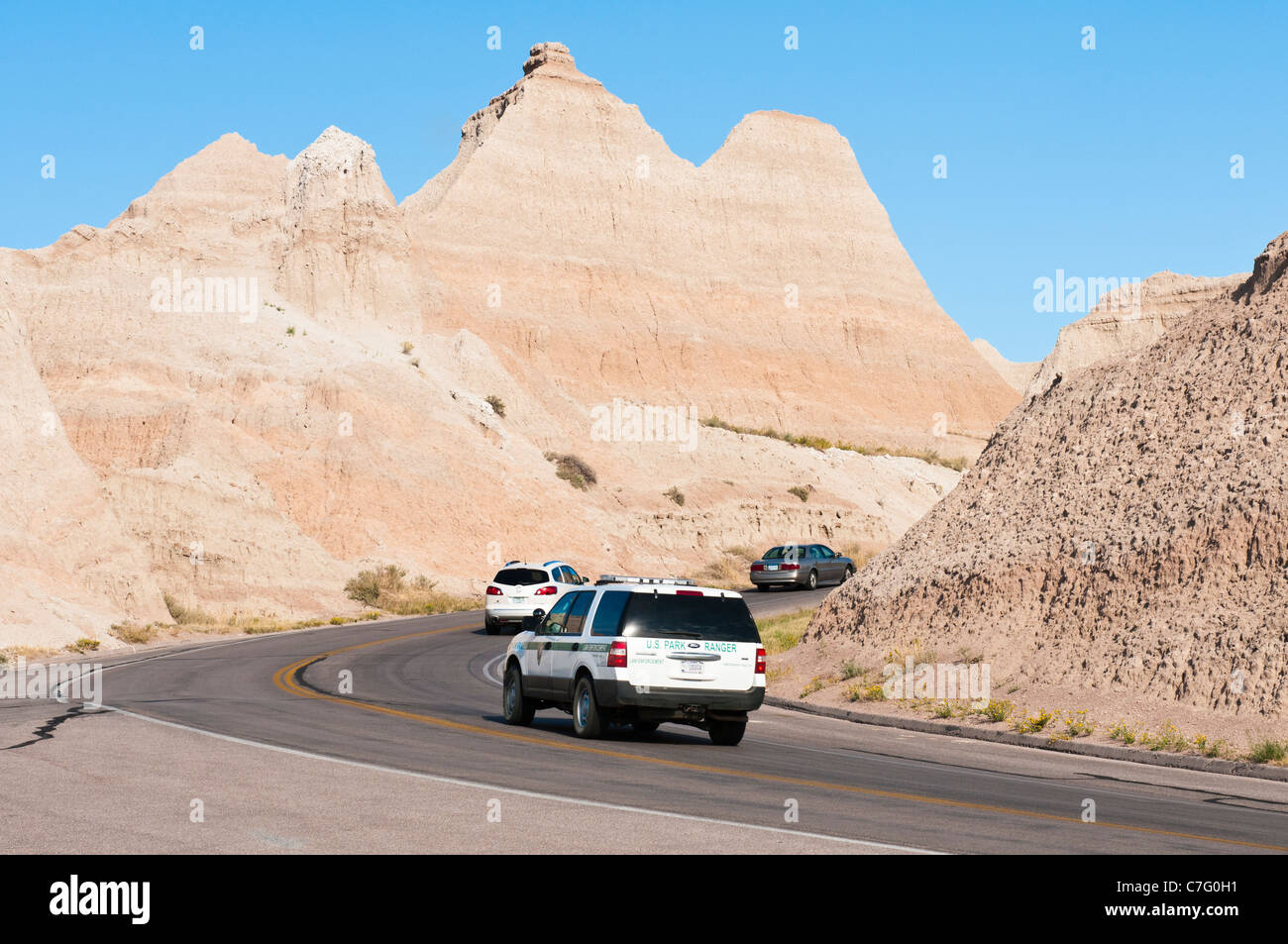 A Park Ranger drives through Badlands National Park in South Dakota ...