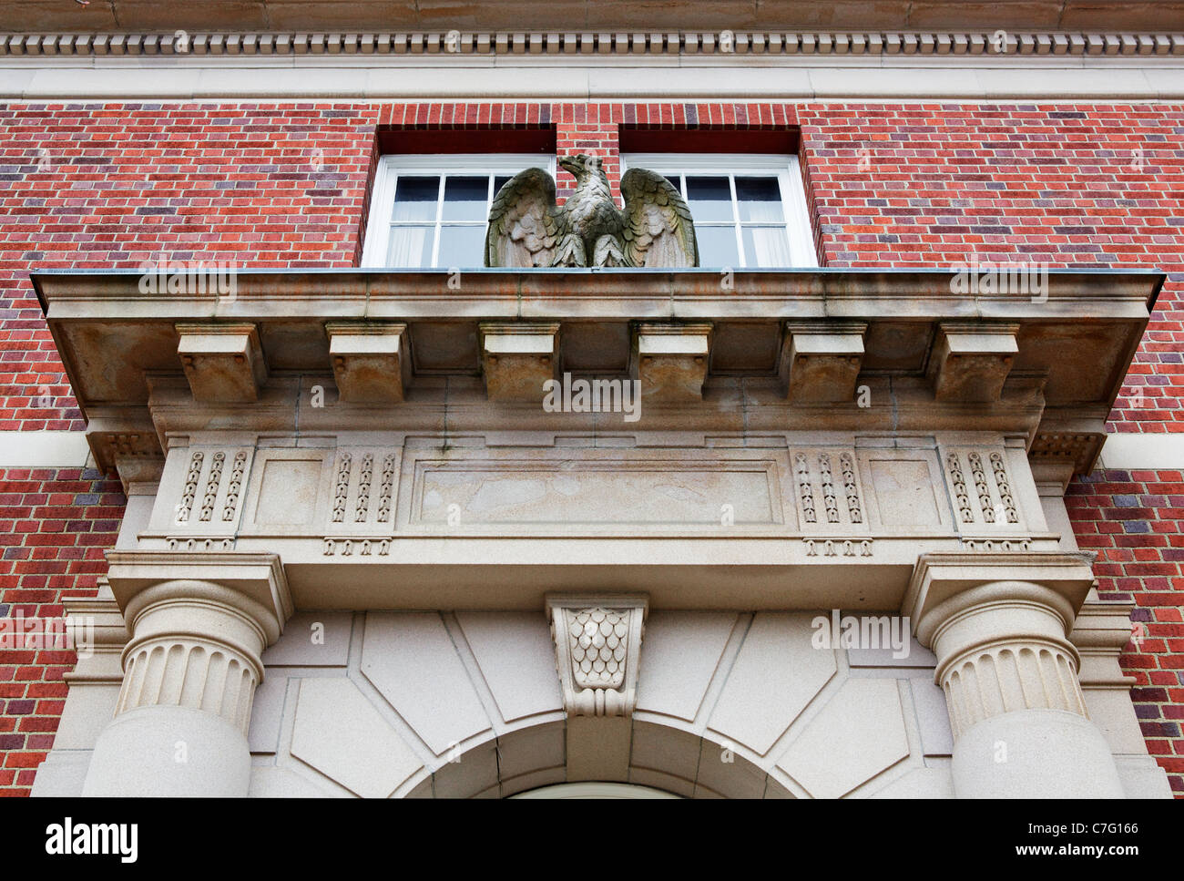 Red brick building with an eagle overlooking the entrance Stock Photo ...
