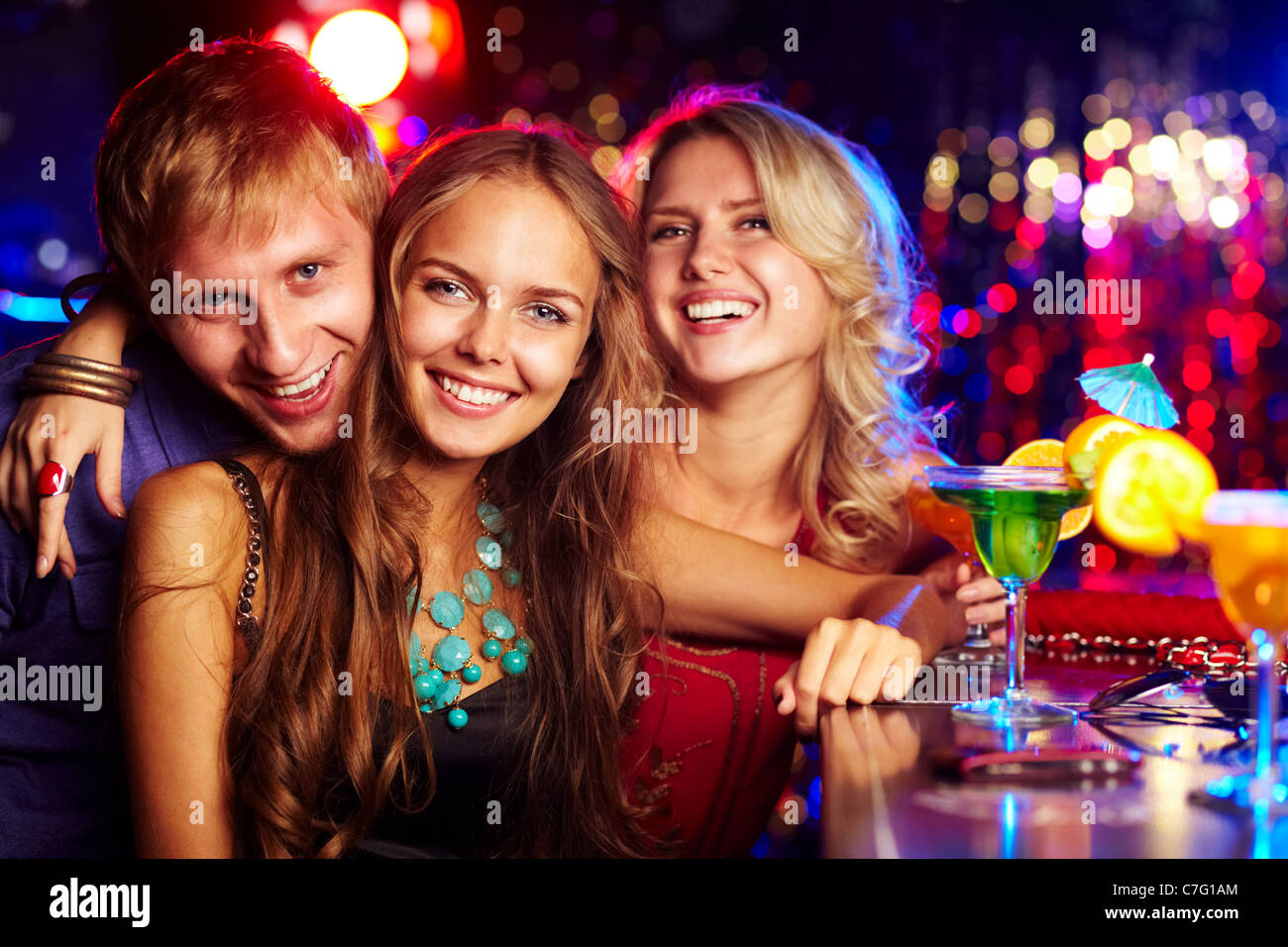 Image of happy friends looking at camera at party Stock Photo - Alamy