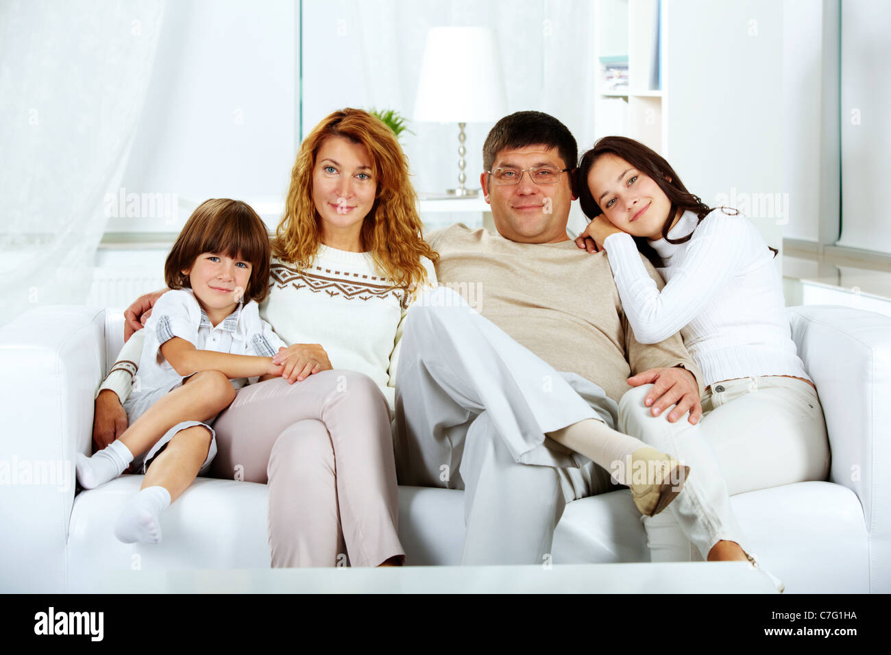 Photo of happy family looking at camera at home Stock Photo - Alamy