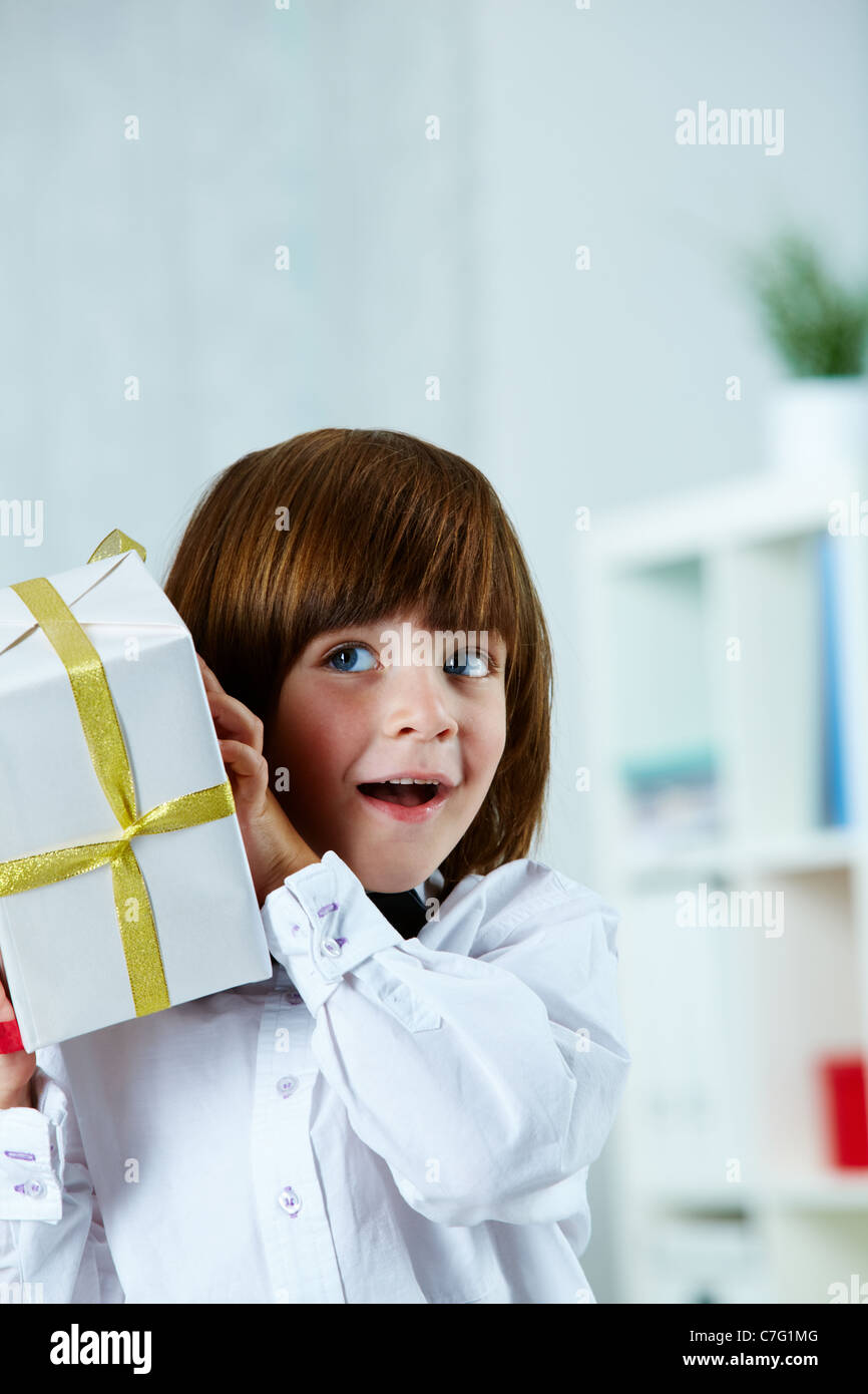 Photo of surprised boy with giftbox Stock Photo - Alamy