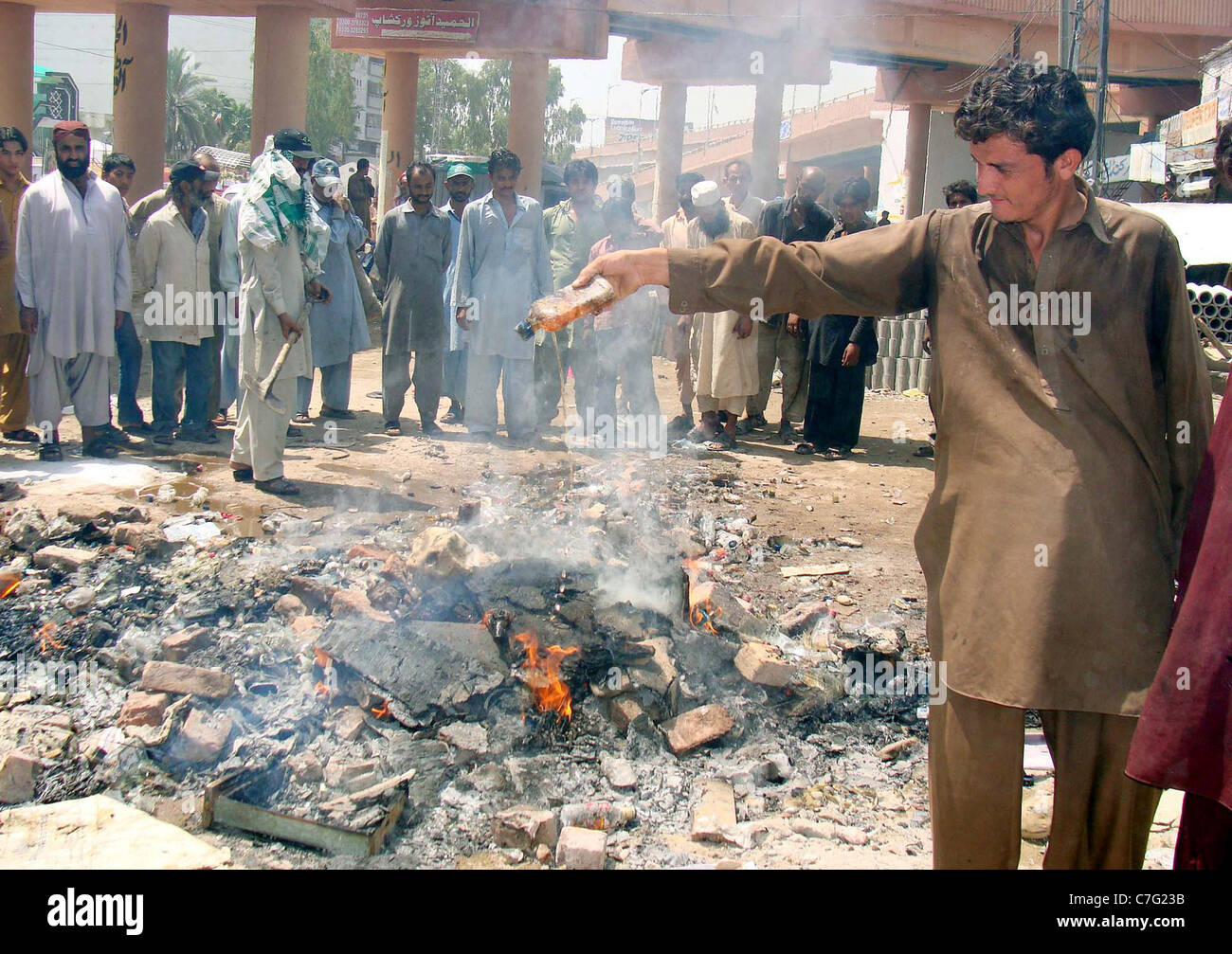 Angry protesters burn liquor bottles after attack at a wine shop during ...
