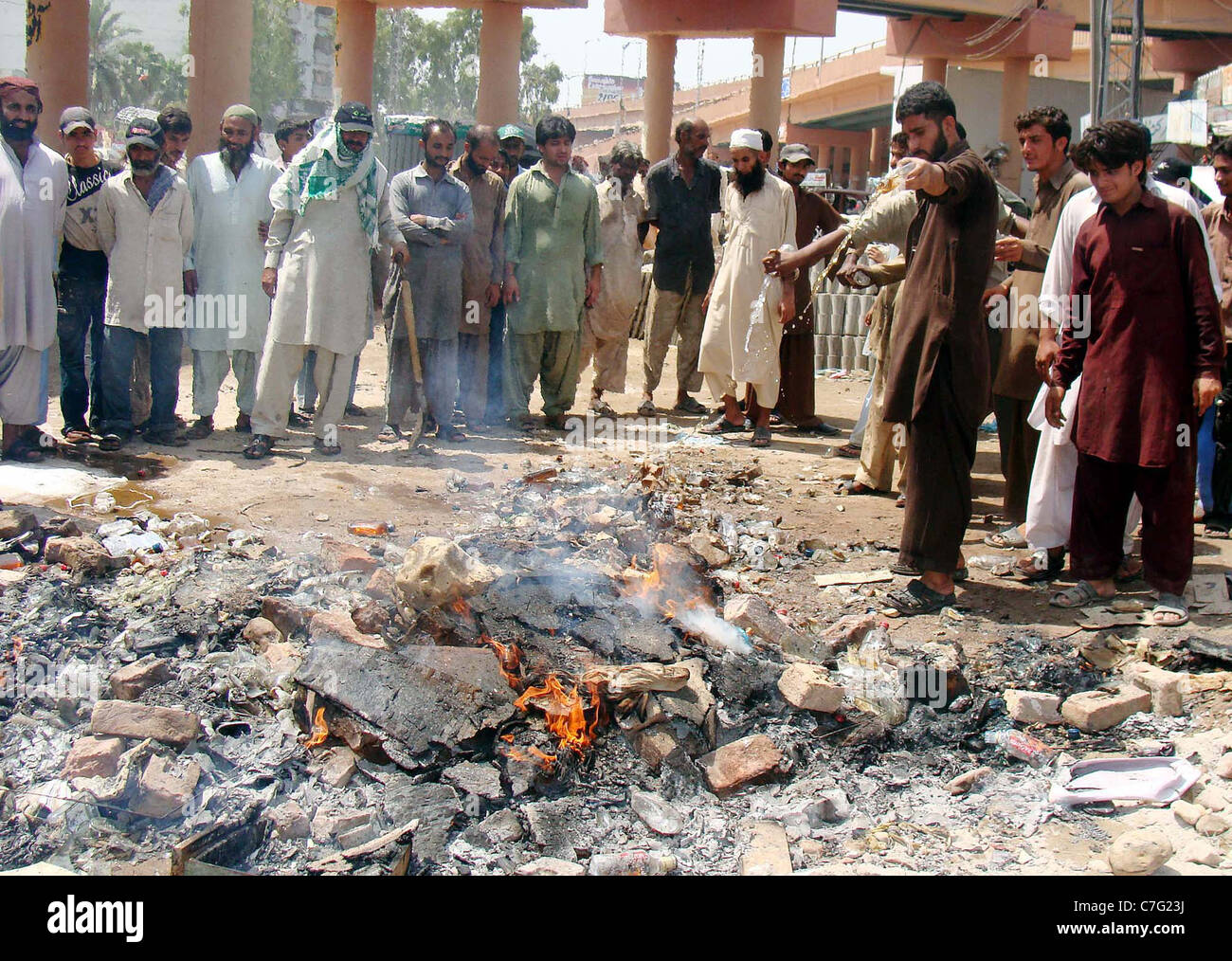 Angry protesters burn liquor bottles after attack at a wine shop during ...