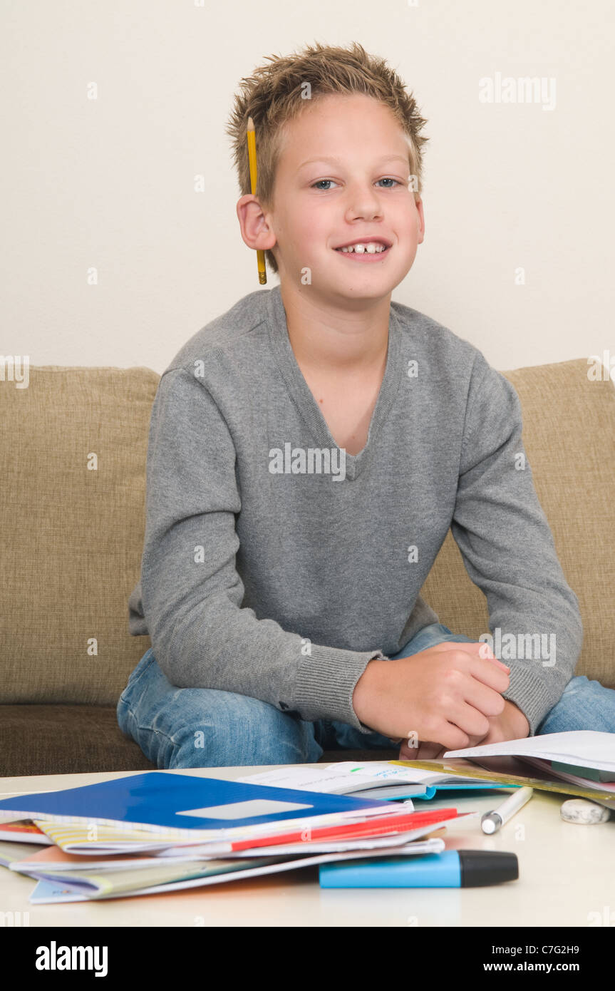 Boy doing his homework in the livingroom Stock Photo - Alamy