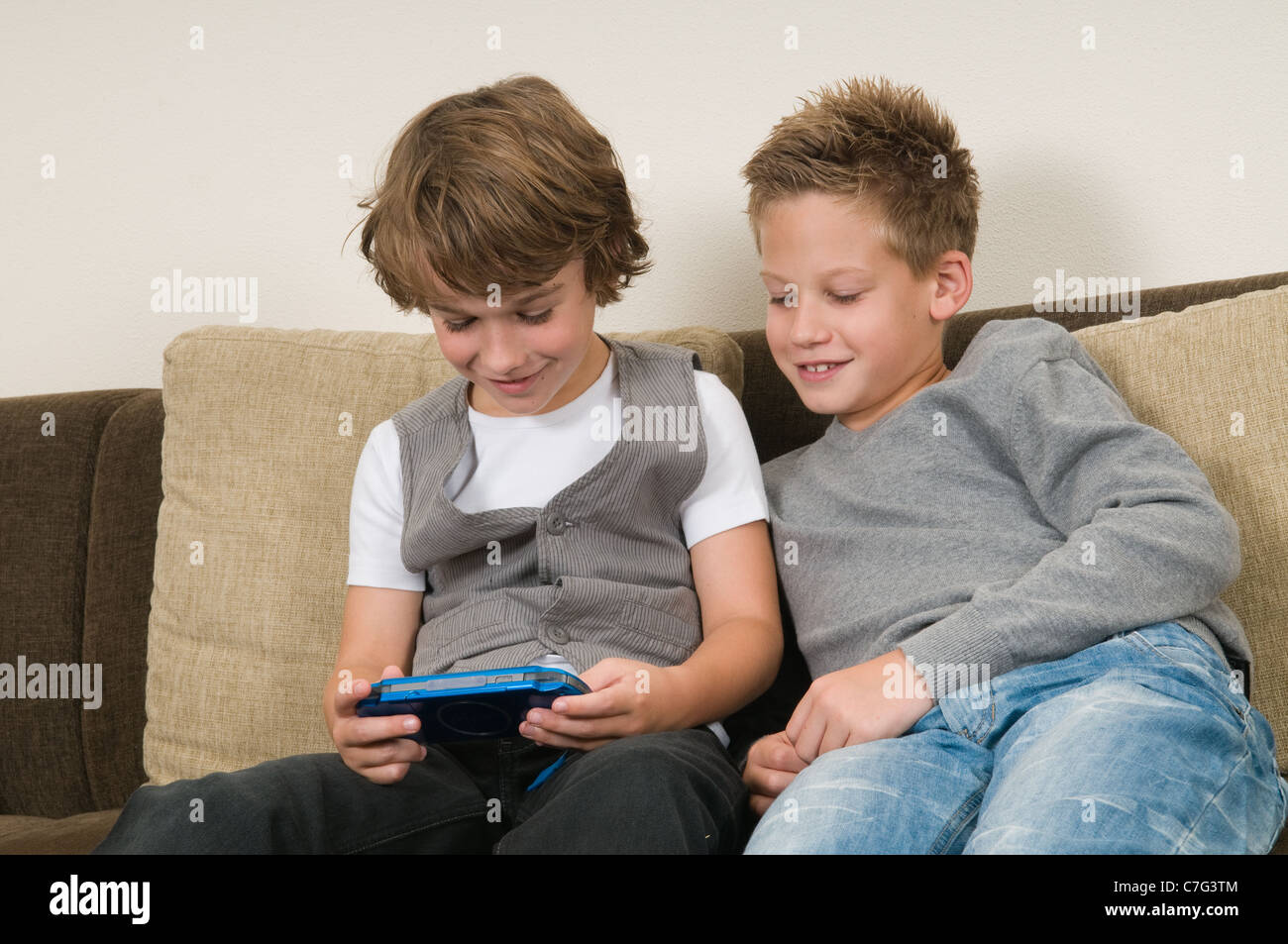 Two friends are playing a computergame on a gaming console Stock Photo ...