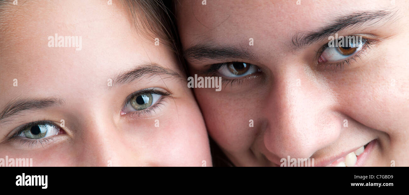 Close-up image of two young girl faces together Stock Photo - Alamy