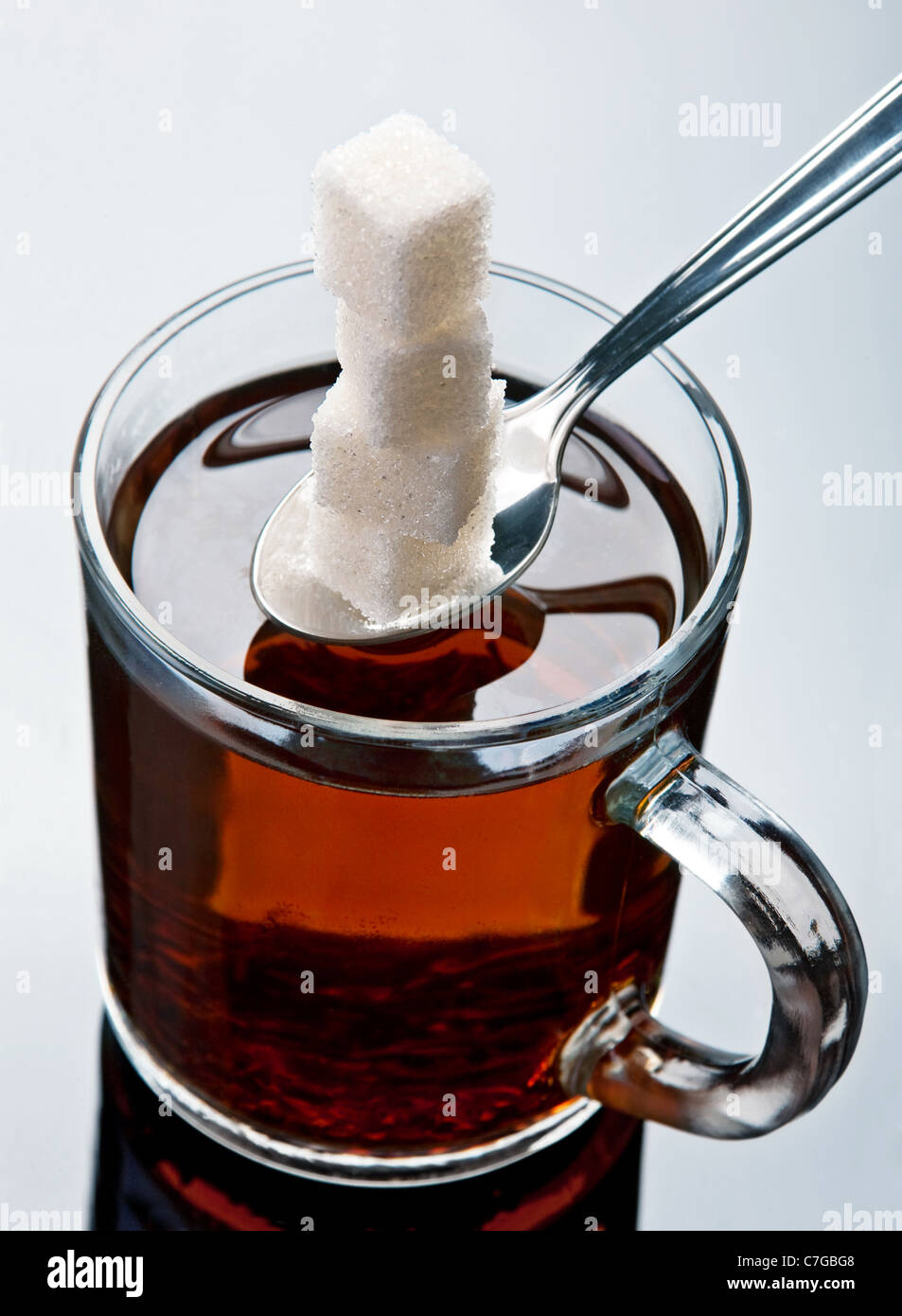 Added lump sugar in tea beverage closeup Stock Photo - Alamy