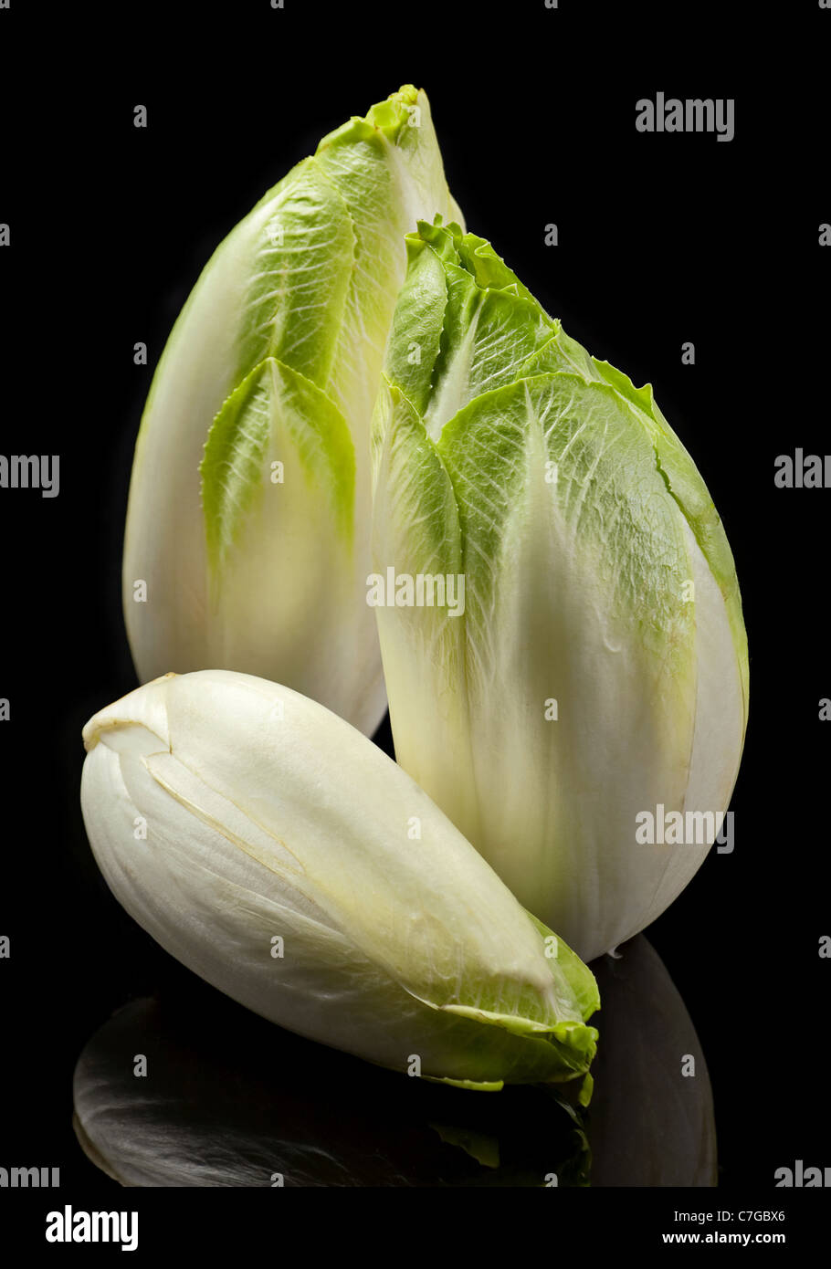 Green chicory vegetable closeup on black background Stock Photo - Alamy