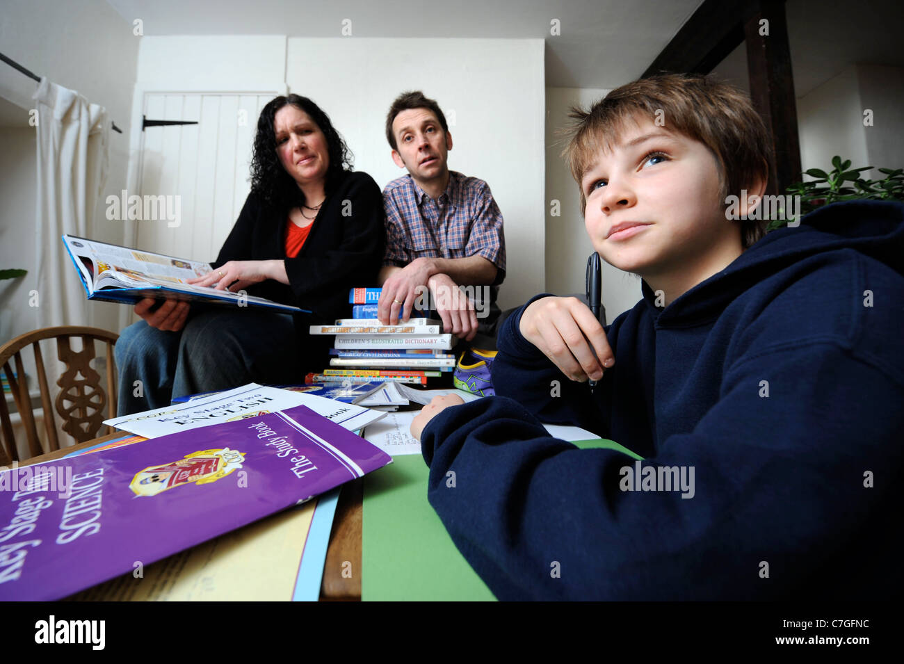Parents with their child being educated at home UK Stock Photo - Alamy
