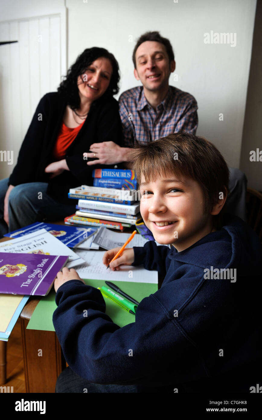 Parents with their child being educated at home UK Stock Photo - Alamy