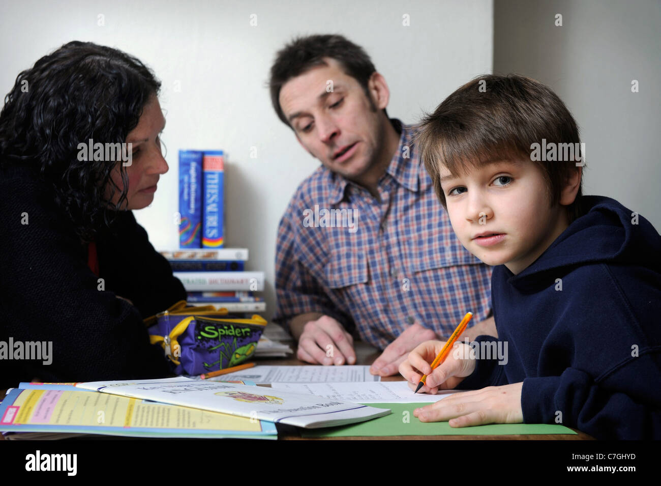 Parents with their child being educated at home UK Stock Photo - Alamy