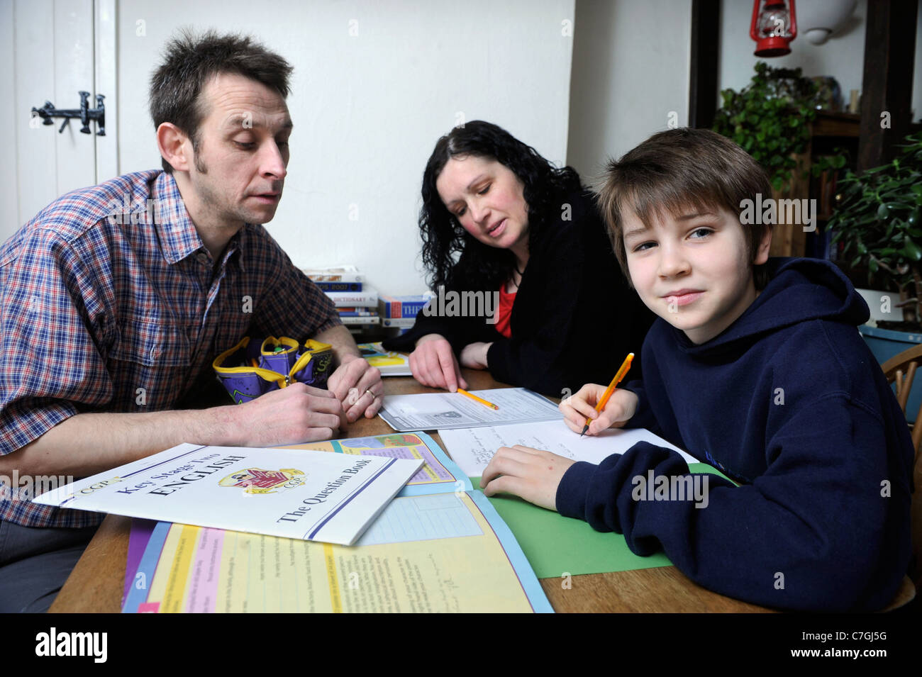Parents with their child being educated at home UK Stock Photo - Alamy