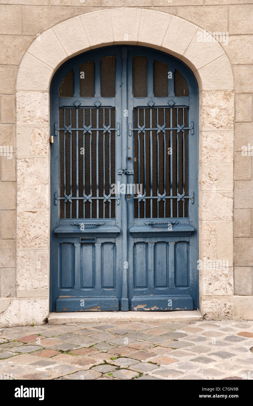 Old wooden door in typical blue color, entrance to the medieval house ...