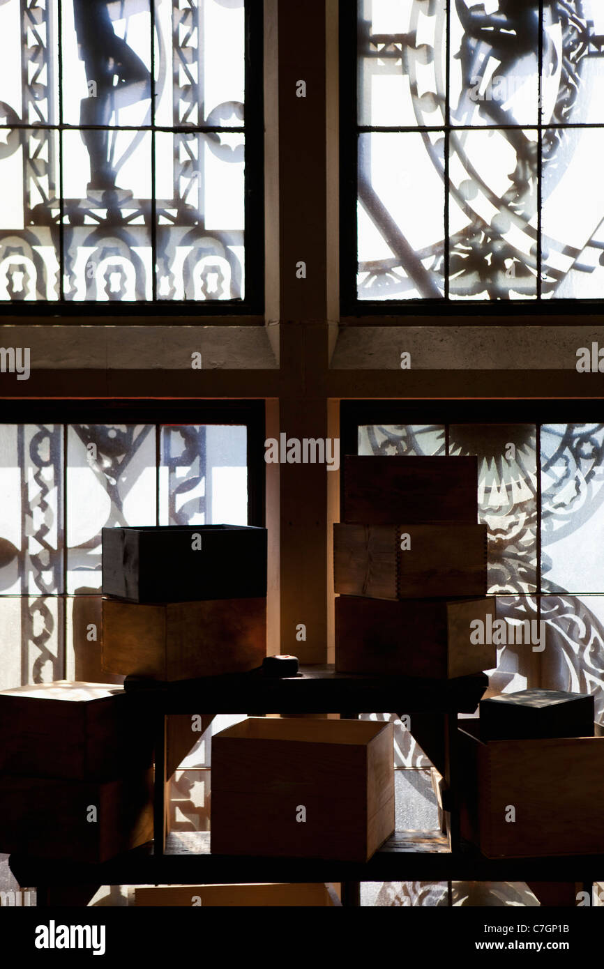 Old wooden boxes inside of a room with clockworks outside the windows ...