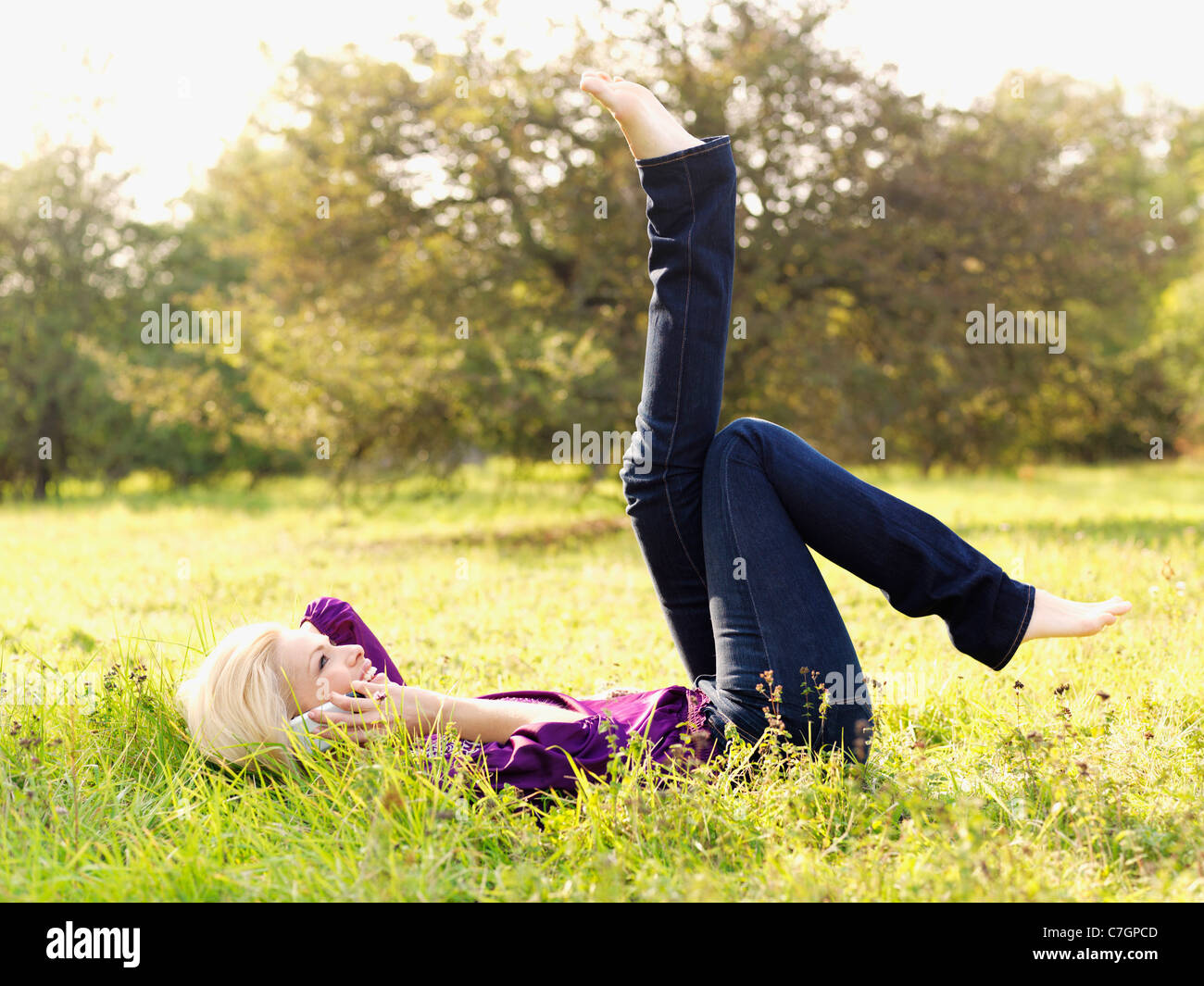 Woman lying on back legs hi-res stock photography and images - Alamy