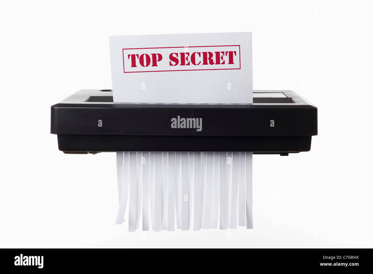 A document with TOP SECRET on it being shredded in a paper shredder ...