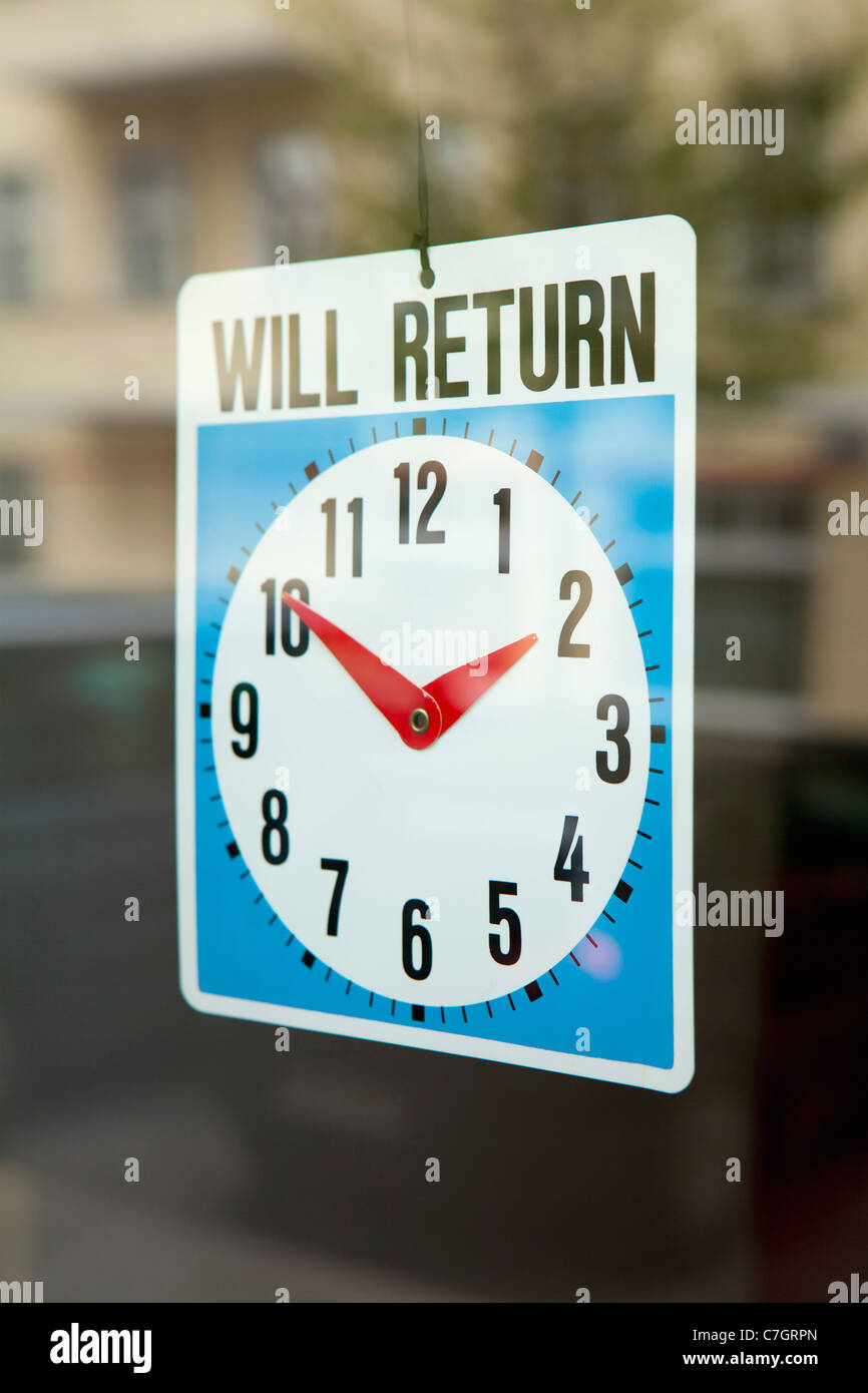 A WILL RETURN sign hanging in the window of a shop door Stock Photo - Alamy