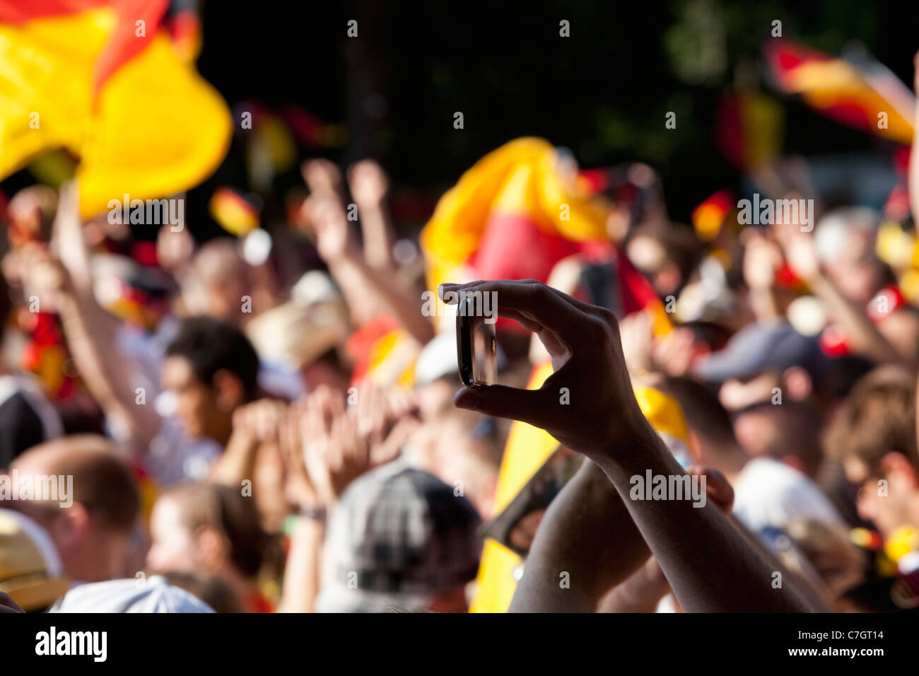 One Person Standing Up In A Crowd